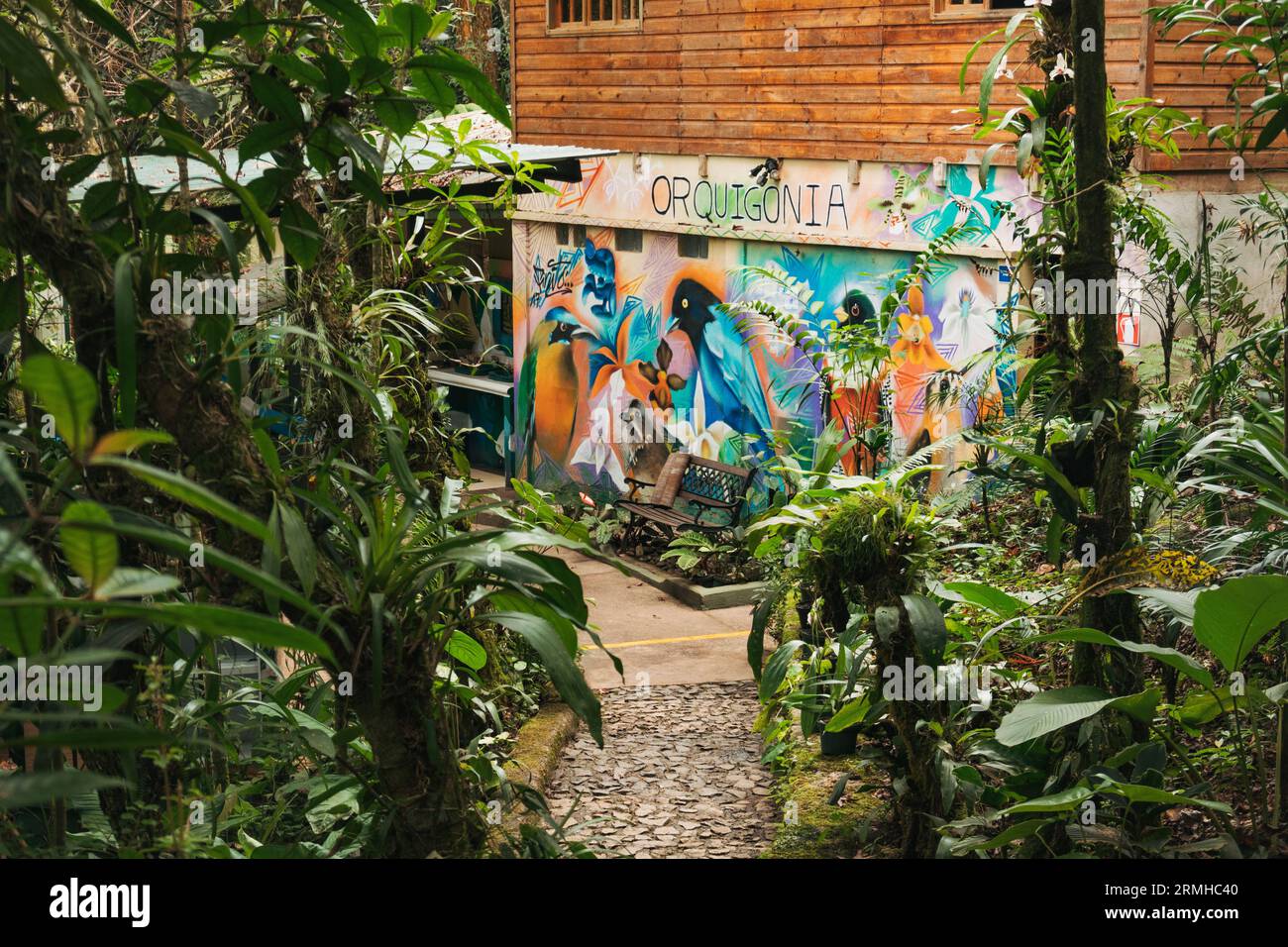 a path leads to a building with a mural at the Orquigonia Orchid ...