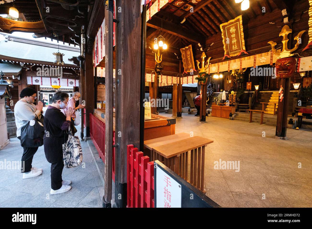 Japan, Fukuoka. Kushida Shinto Shrine. Worshippers Praying in front of ...