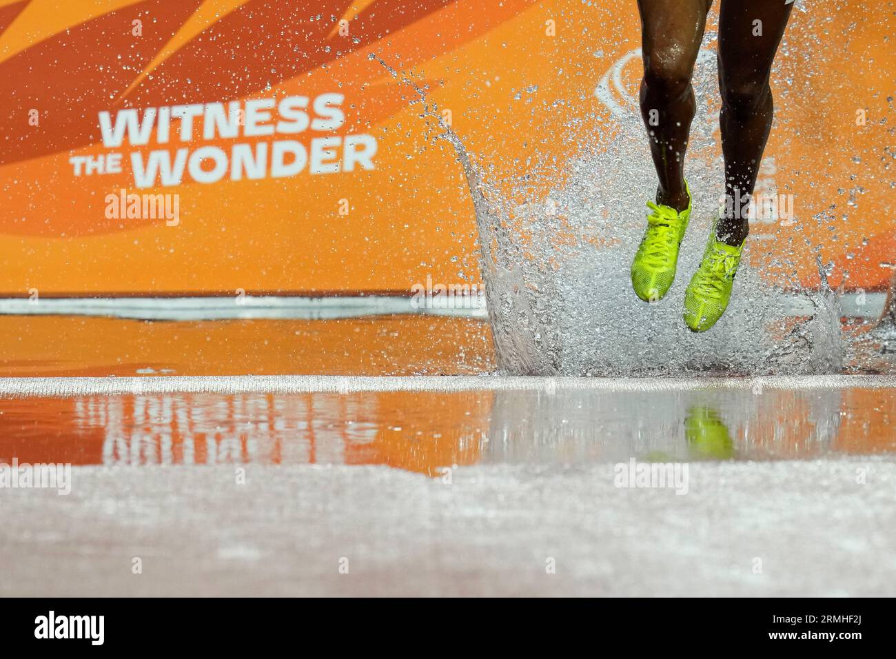 Athletes run through water during the women's steeplechase at the World ...