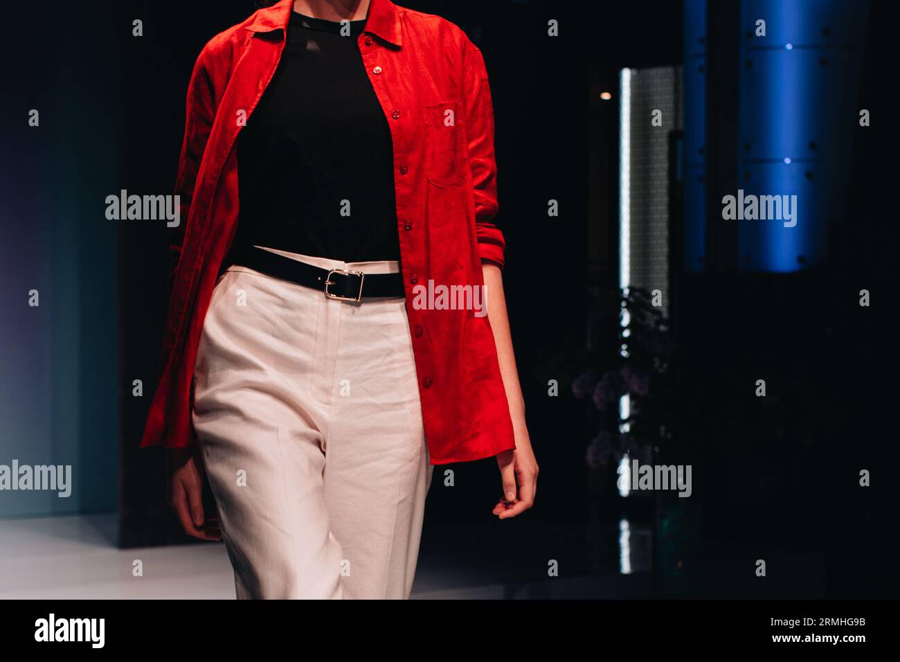 Classy white pants, black top and red shirt with buttons on female body ...