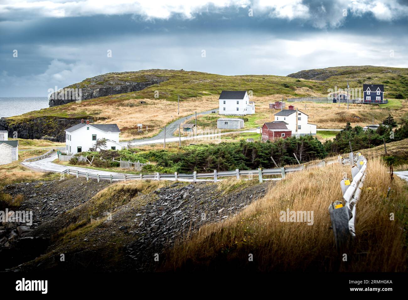East Coast Scene of traditional homes overlooking high rocky cliffs and ...
