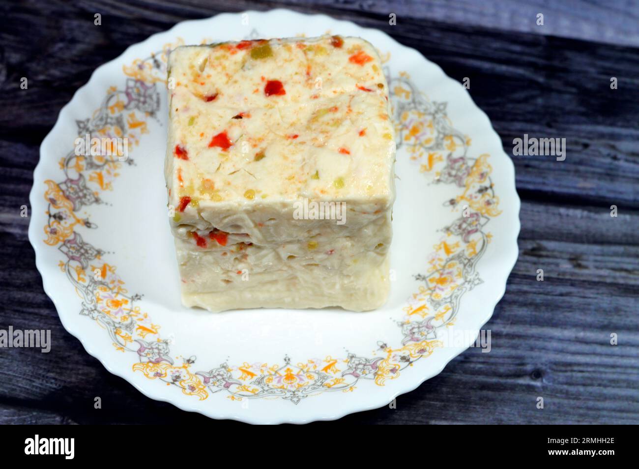 A plate with a cube of Egyptian barrel Baramily white cheese with ...