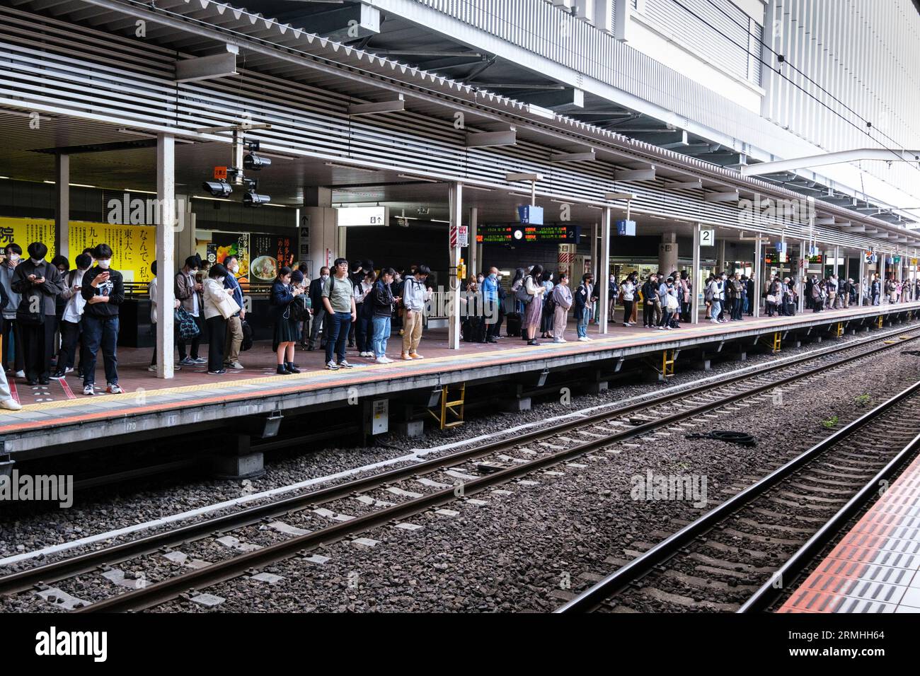Japan, Fukuoka. Hakata Train Station Passengers Waiting for Train Stock Photo - Alamy