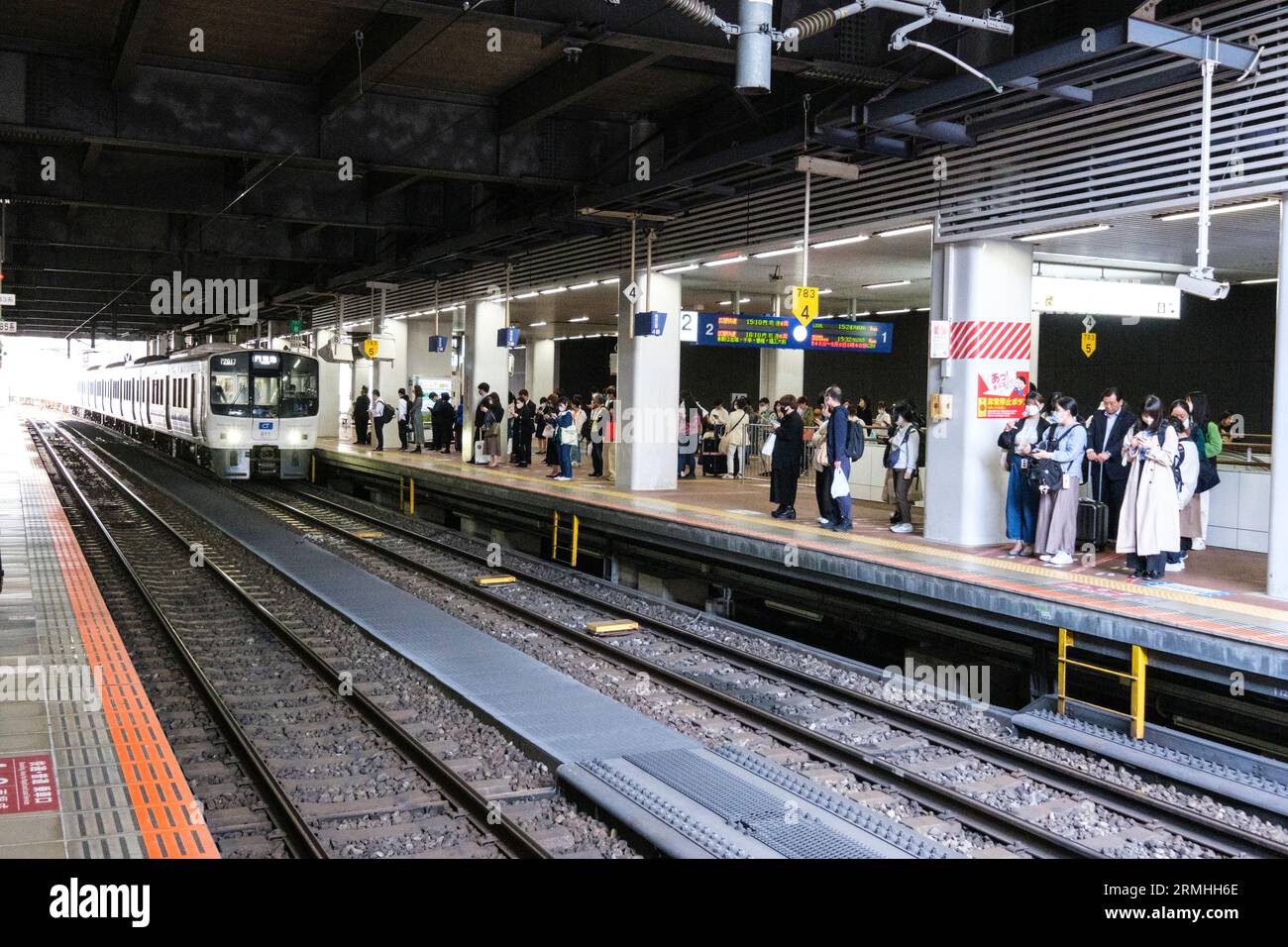 Japan, Fukuoka. Hakata Train Station Passengers Waiting for Train Stock Photo - Alamy