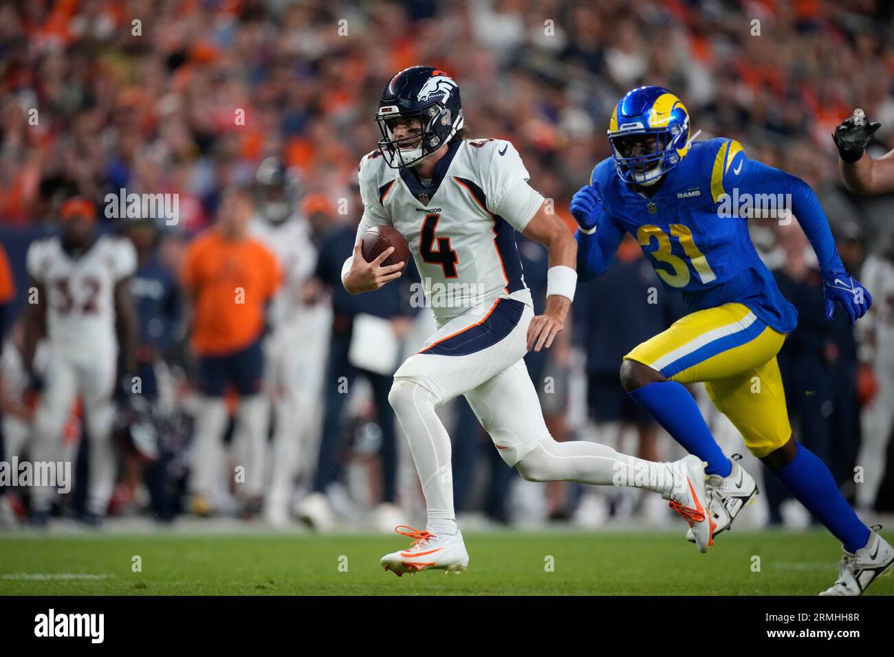 Denver Broncos quarterback Jarrett Stidham (4) is pursued by Los Angeles Rams linebacker Nick ...
