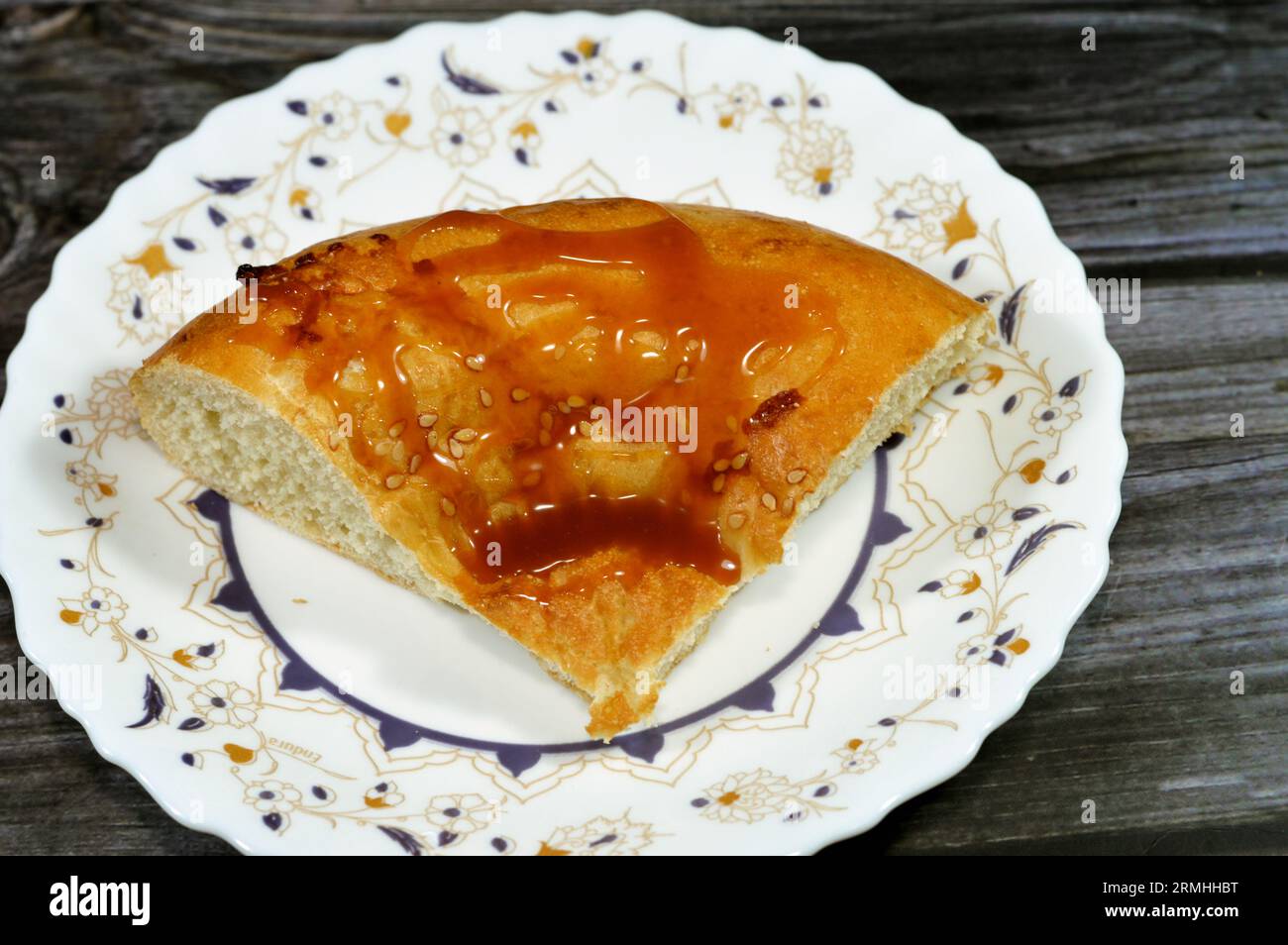 Caramel sauce topping on a tandyr nan Uzbek bread, a type of Central ...