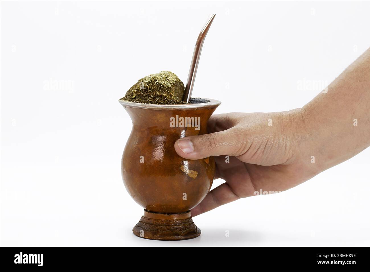 hand holding cup of mate, called chimarrão, from South America ...