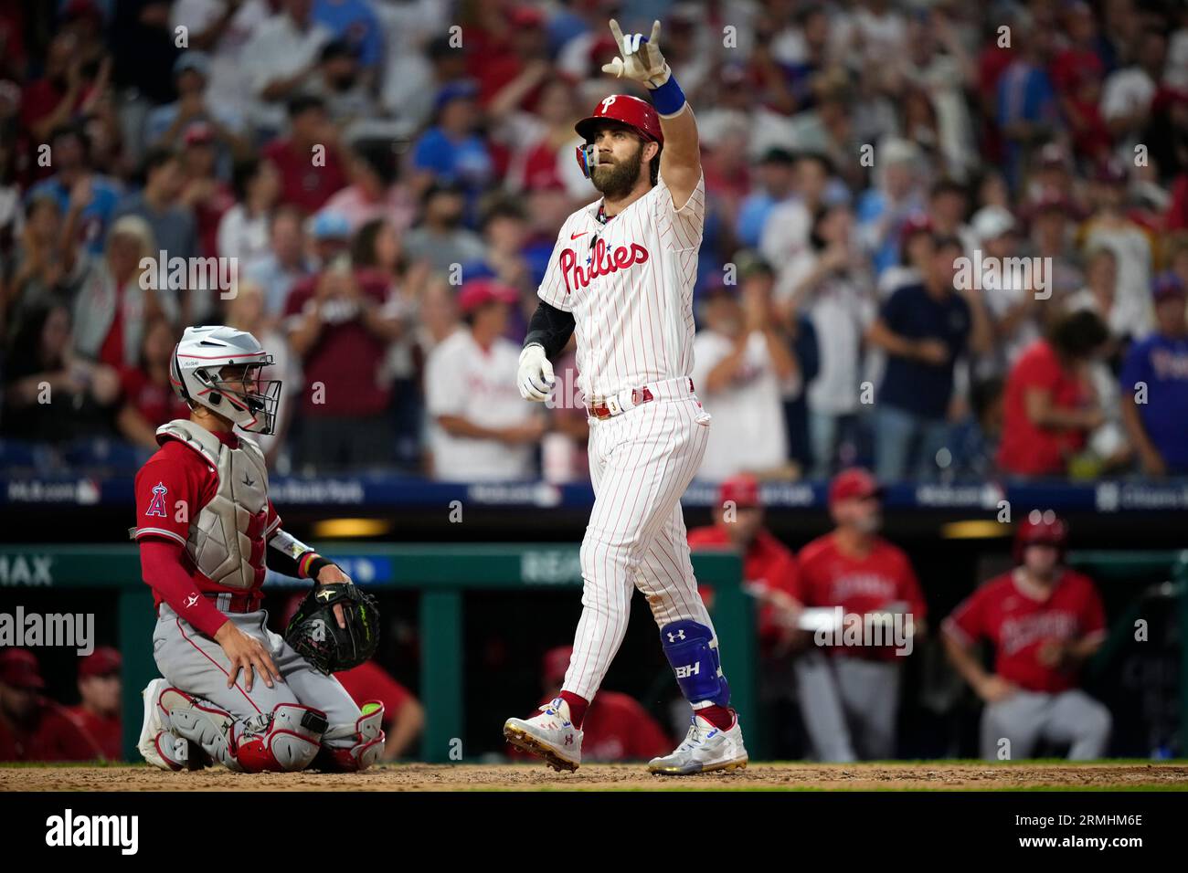 Philadelphia Phillies' Bryce Harper, right, reacts after hitting a two ...