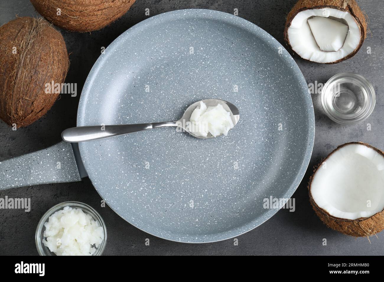 Flat lay composition with frying pan and organic coconut cooking oil on ...