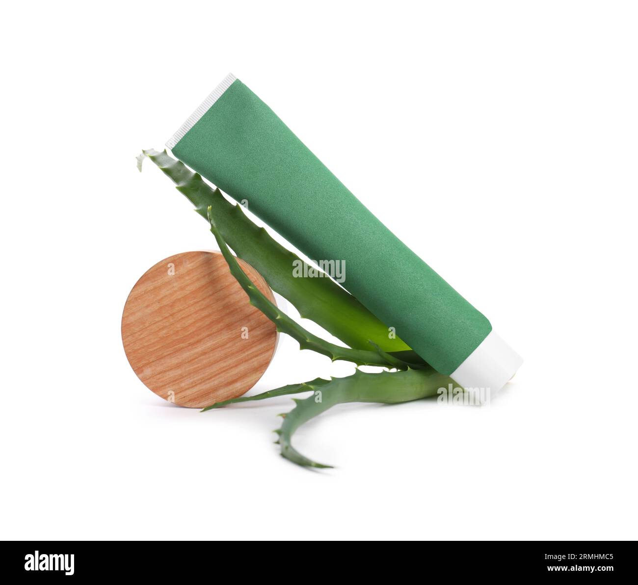 Tube of toothpaste, aloe vera leaves and wooden decor on white ...