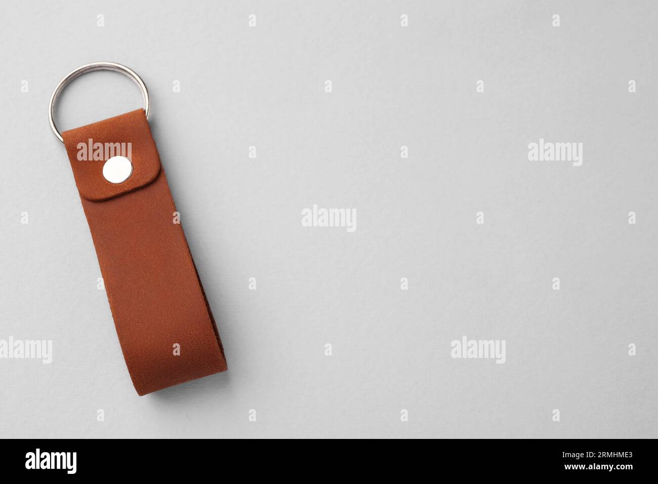 Leather keychain with Ukrainian coat of arms on light grey background ...