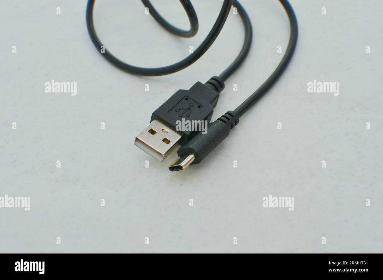 Black USB Type-C cable detail highlighted on a clear surface, perfect ...