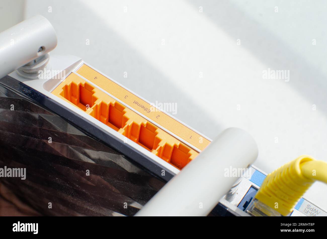 Close-up detail of a modern Wi-Fi router, with multiple inputs and ...