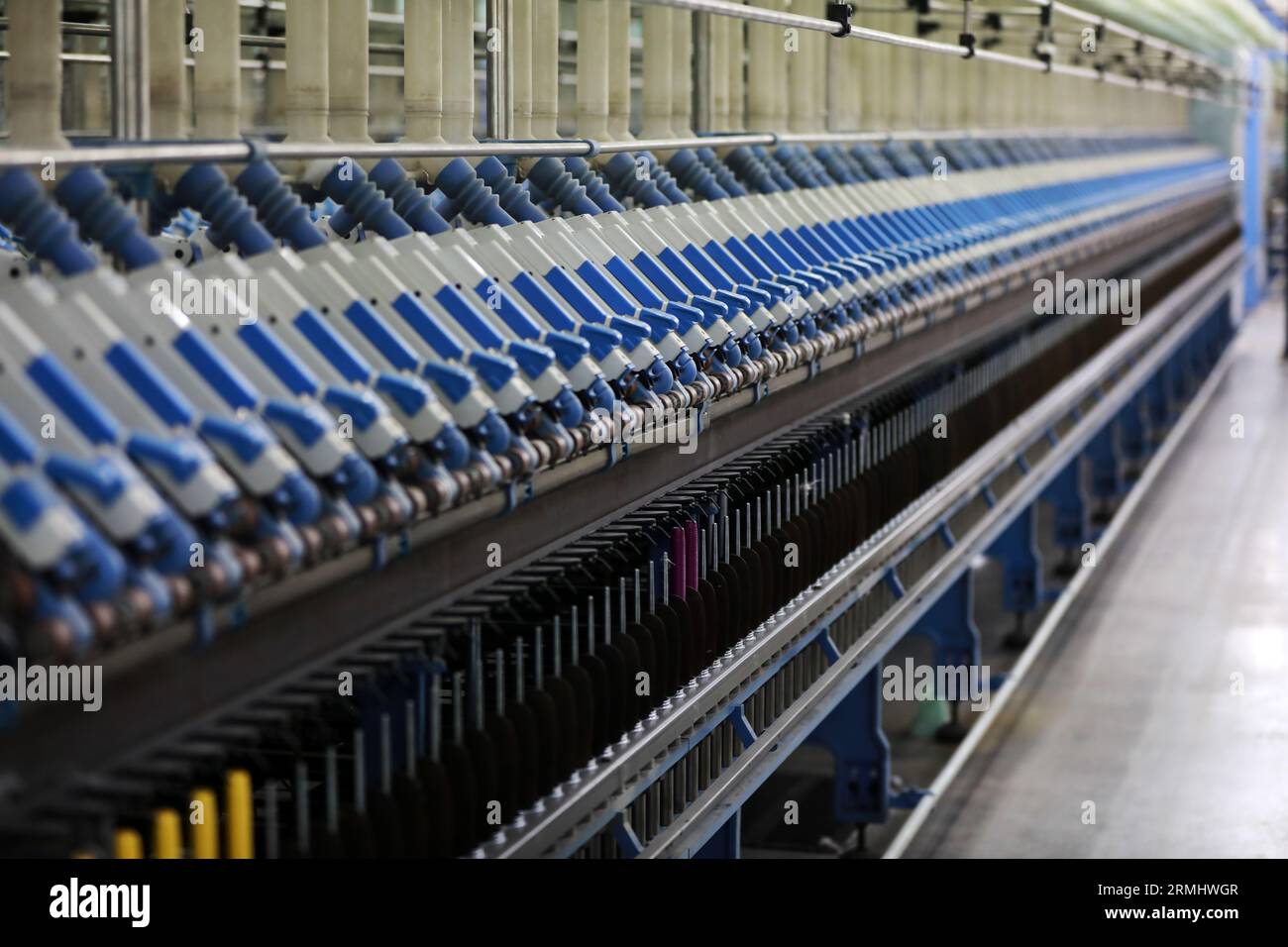 Machinery and equipment in operation in spinning mill Stock Photo - Alamy