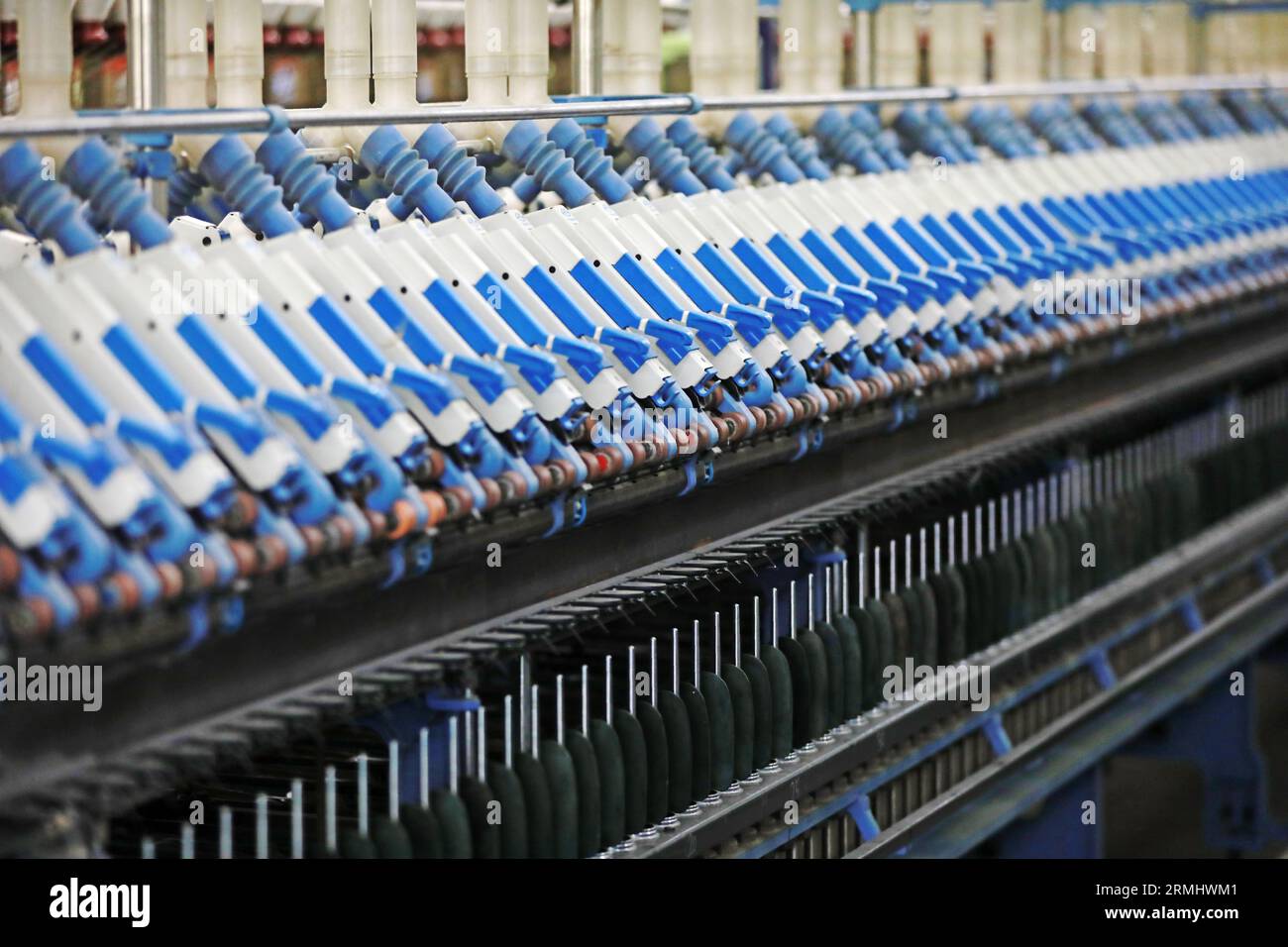 Machinery and equipment in operation in spinning mill Stock Photo - Alamy