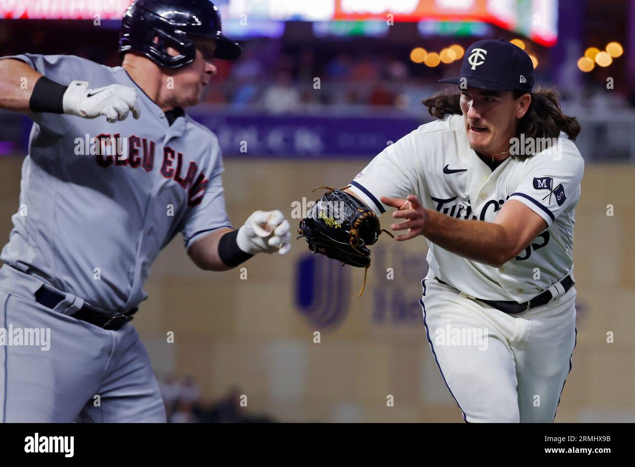 Minnesota Twins reliever Kody Funderburk, right, tags out Cleveland ...