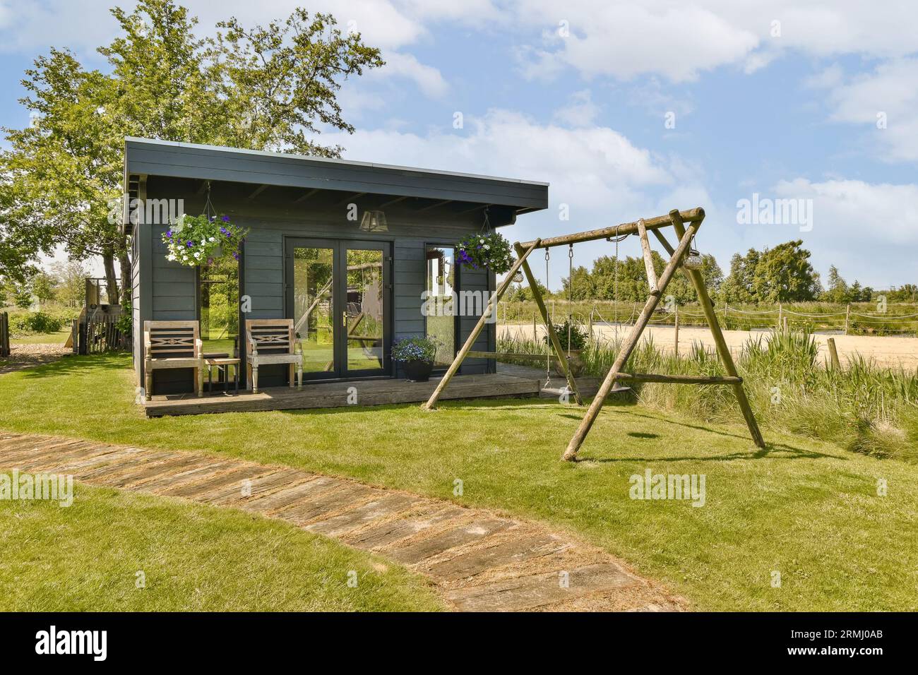 an outdoor play area with swings and swings in the grass, surrounded by ...