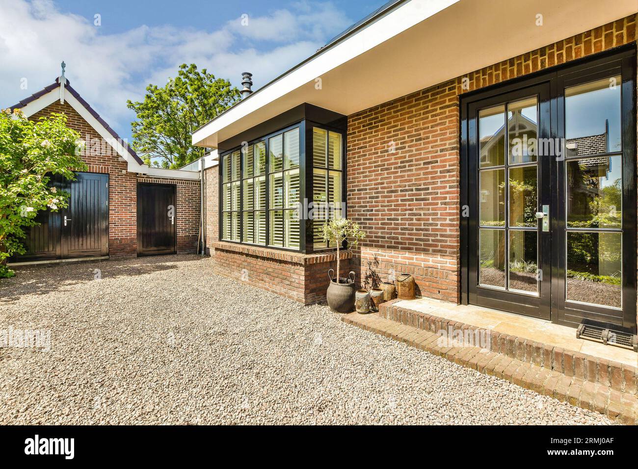 the outside of a house with black windows and brick siding on it's side ...
