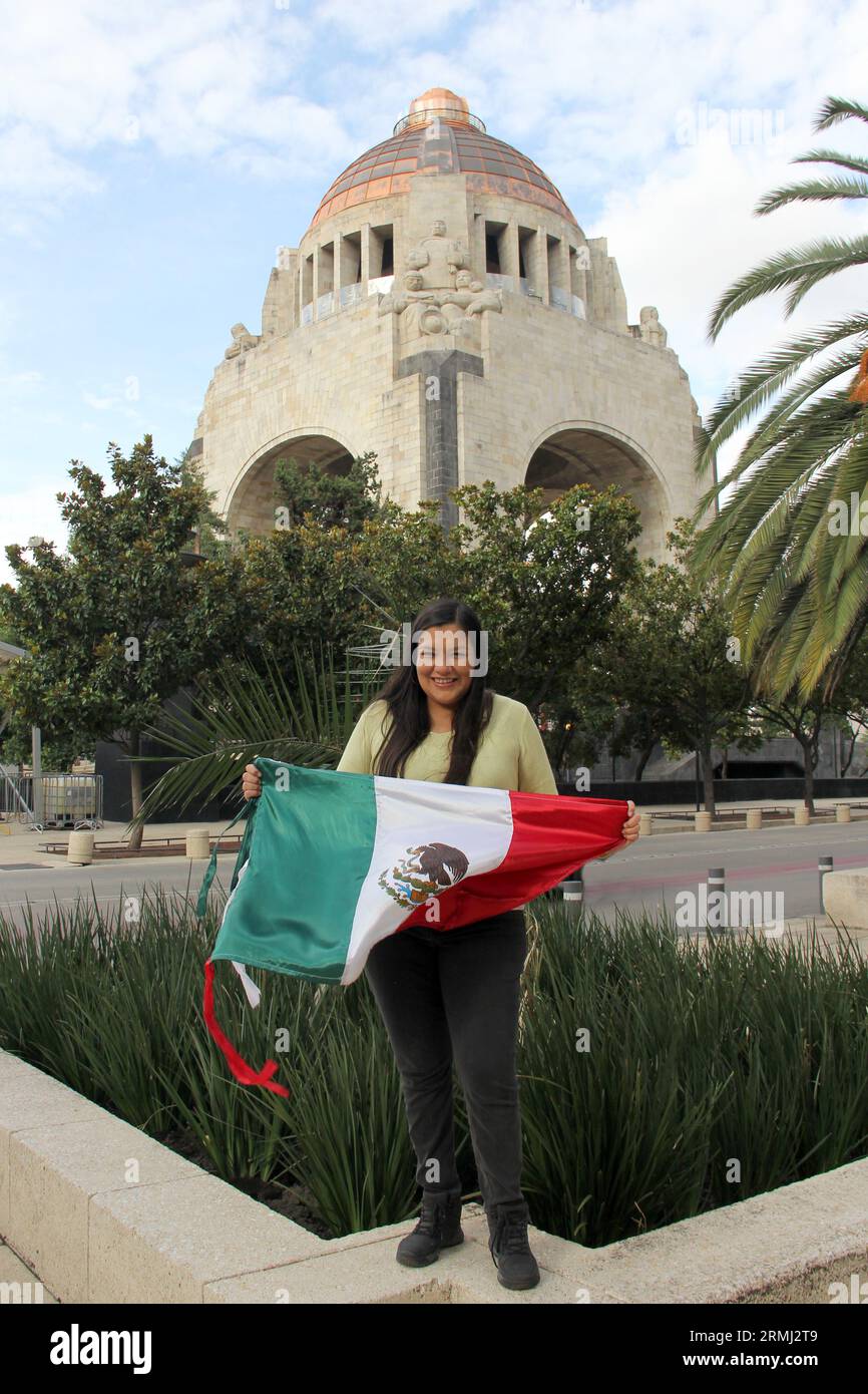 Mexican adult woman shows the flag of Mexico with pride of her culture ...