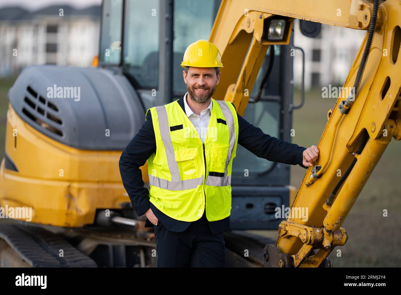 Architect at a construction site. Architect man in helmet and suit at ...