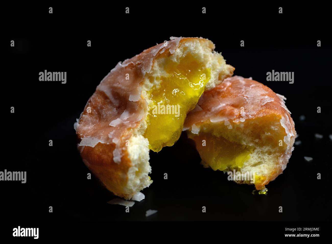 Pineapple filled doughnut broken in half Stock Photo - Alamy