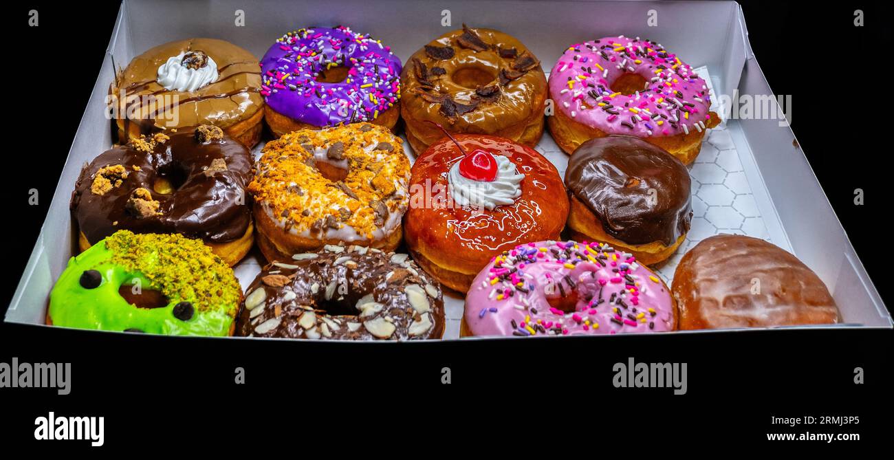 Box of festively decorated doughnuts Stock Photo - Alamy