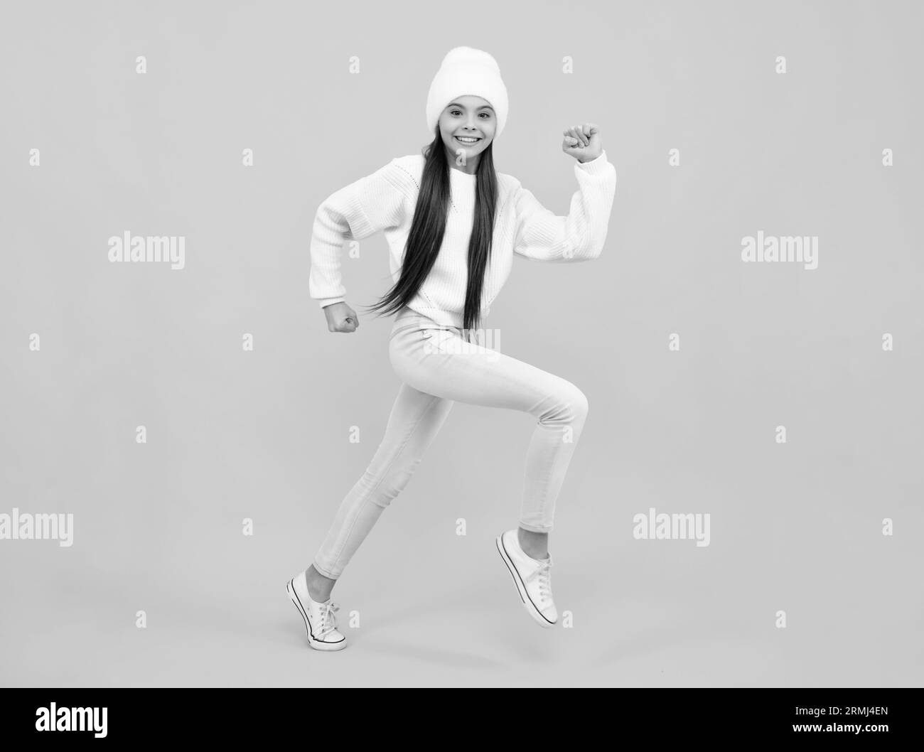 Happiness, freedom, motion and child. Young teenager girl jumping over ...