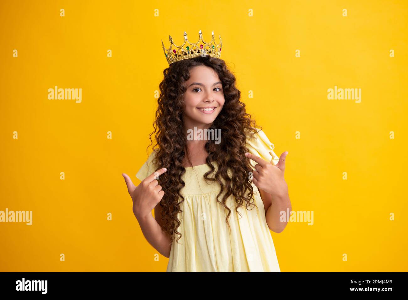 Little queen wearing golden crown. Teenage girl princess holding crown ...