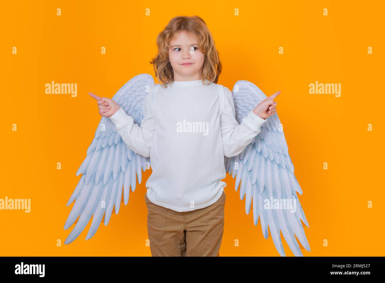 Child at angel costume. Kid with angel wings. Isolated studio shot ...