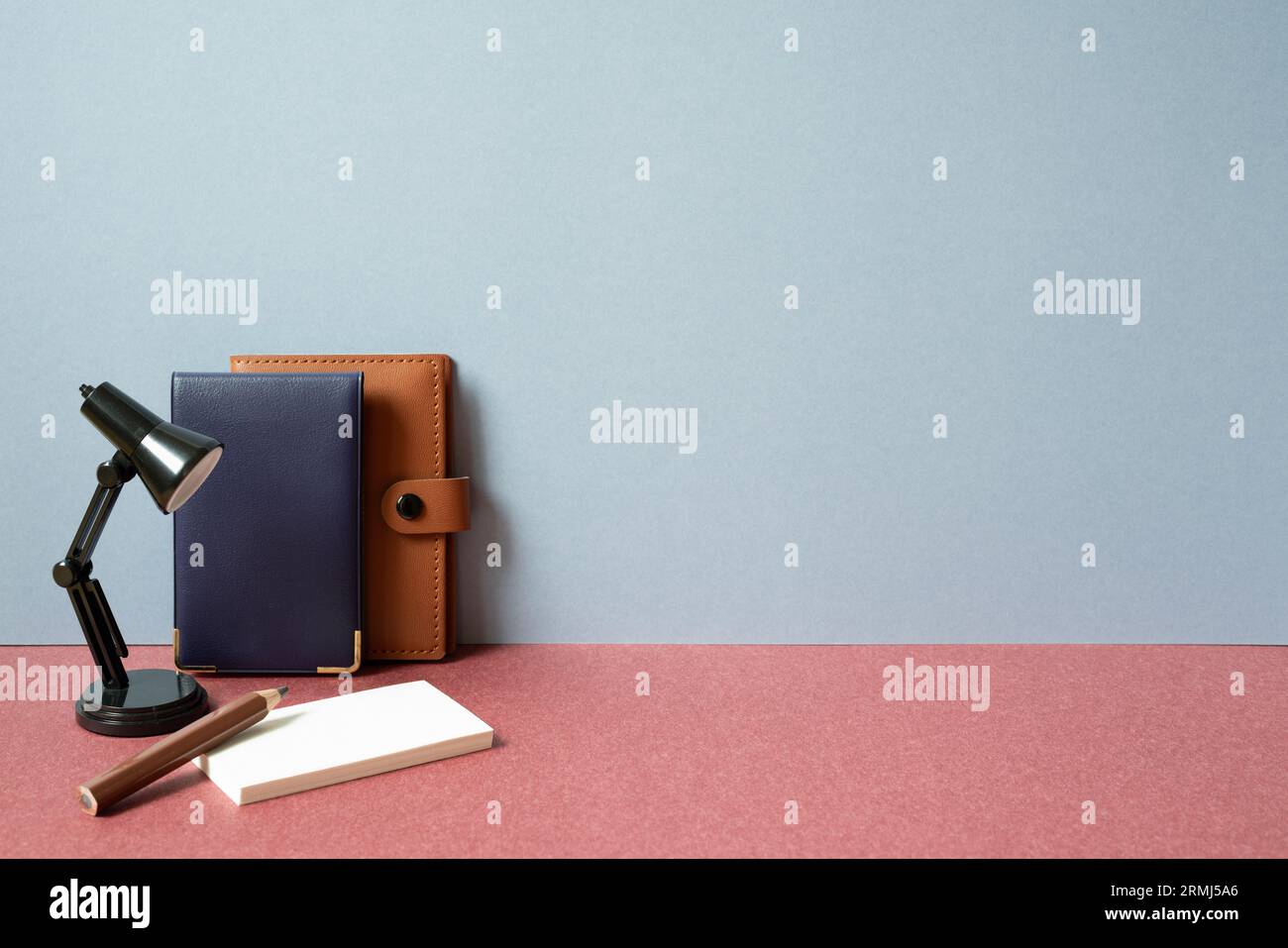 Study and workspace. Notebook, lamp, colored pencil, memo pad on red ...