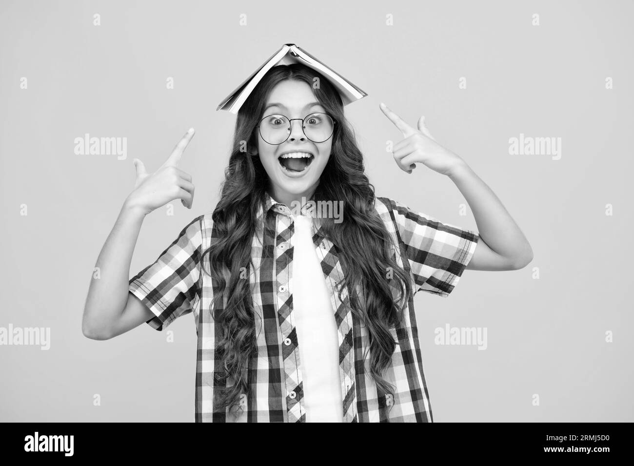 Amazed teen schoolgirl. School child with book. Learning and education ...