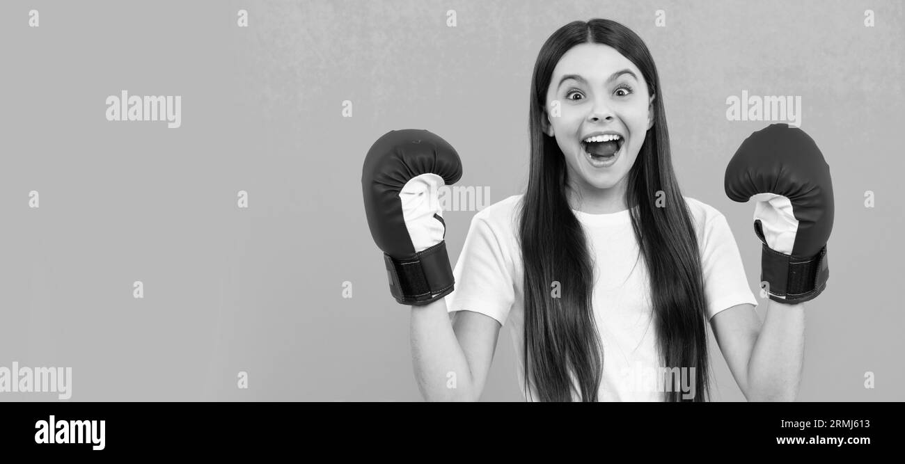surprised teen girl boxer in boxing gloves during sport training, sport ...