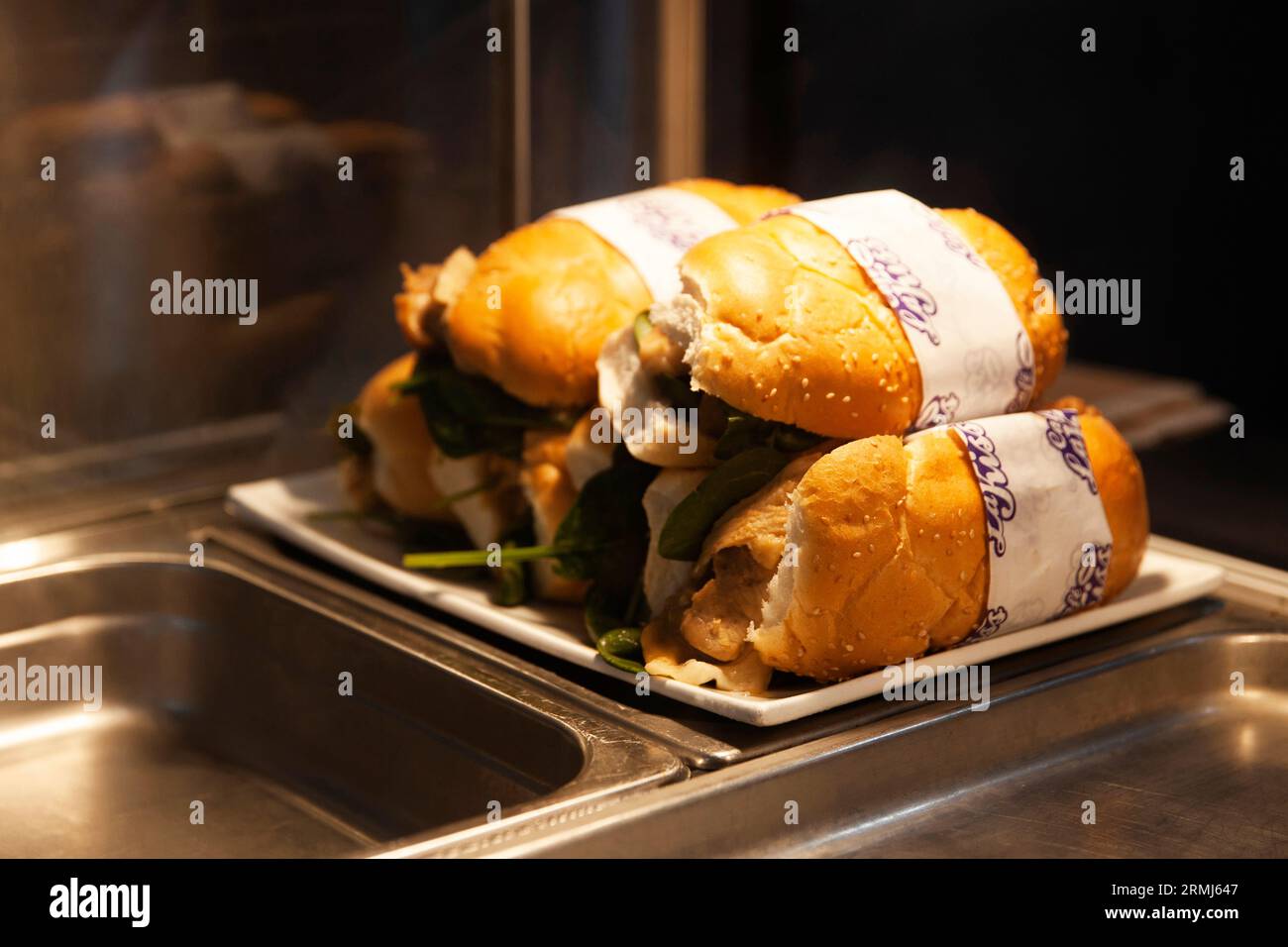 Neatly arranged stacks of lunch sandwiches are placed within commercial ...