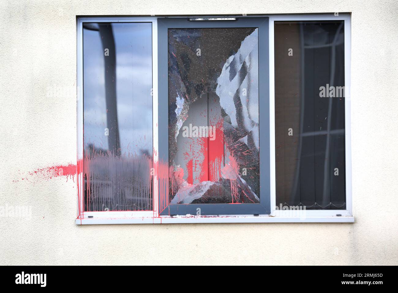 A window is smashed and red paint is sprayed inside the office at the ...