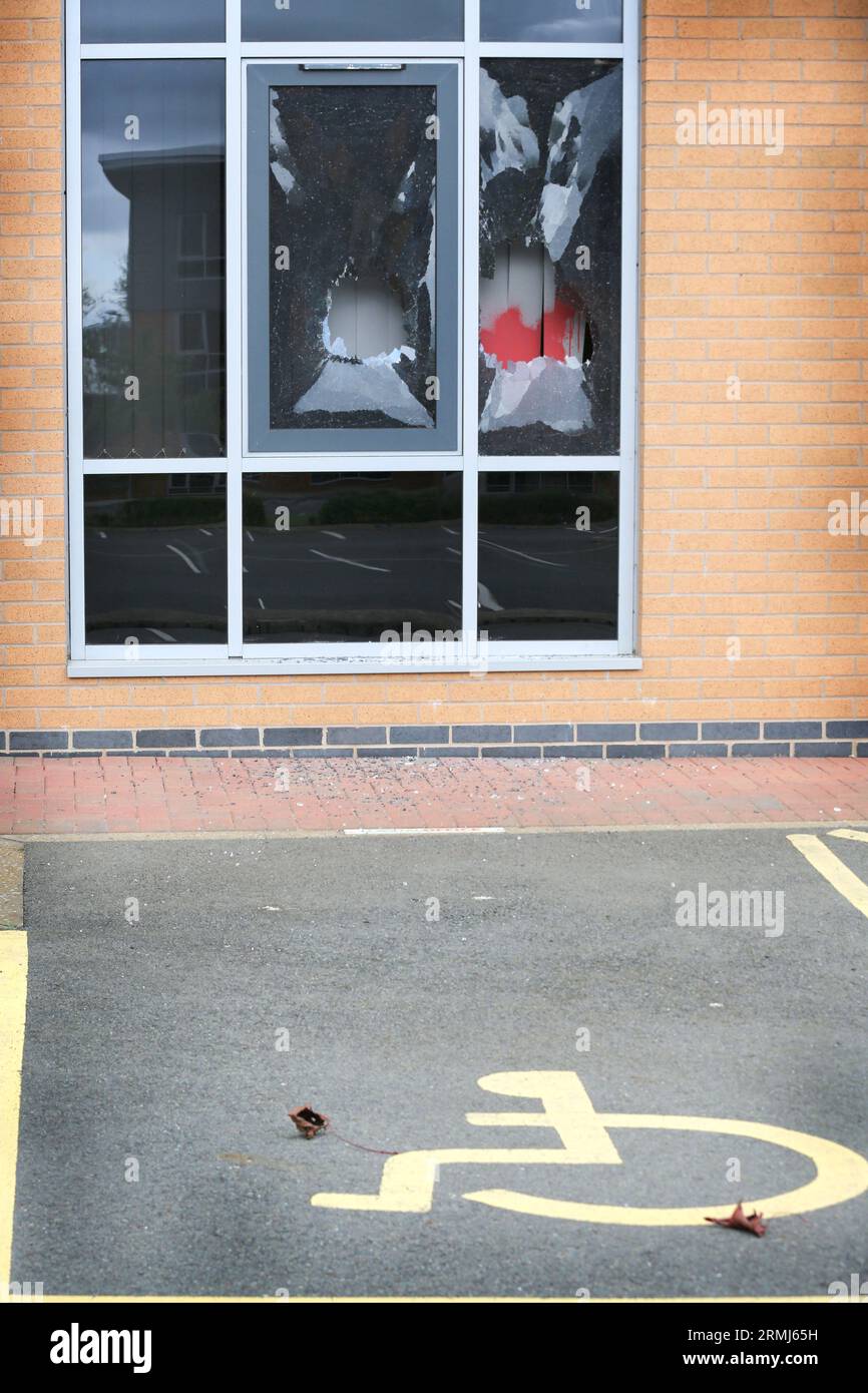 The outside of the modern building shows red paint on it's face and a ...