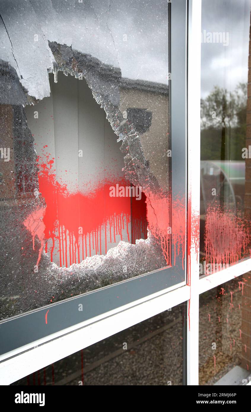 A window is smashed and red paint is sprayed inside the office at the ...