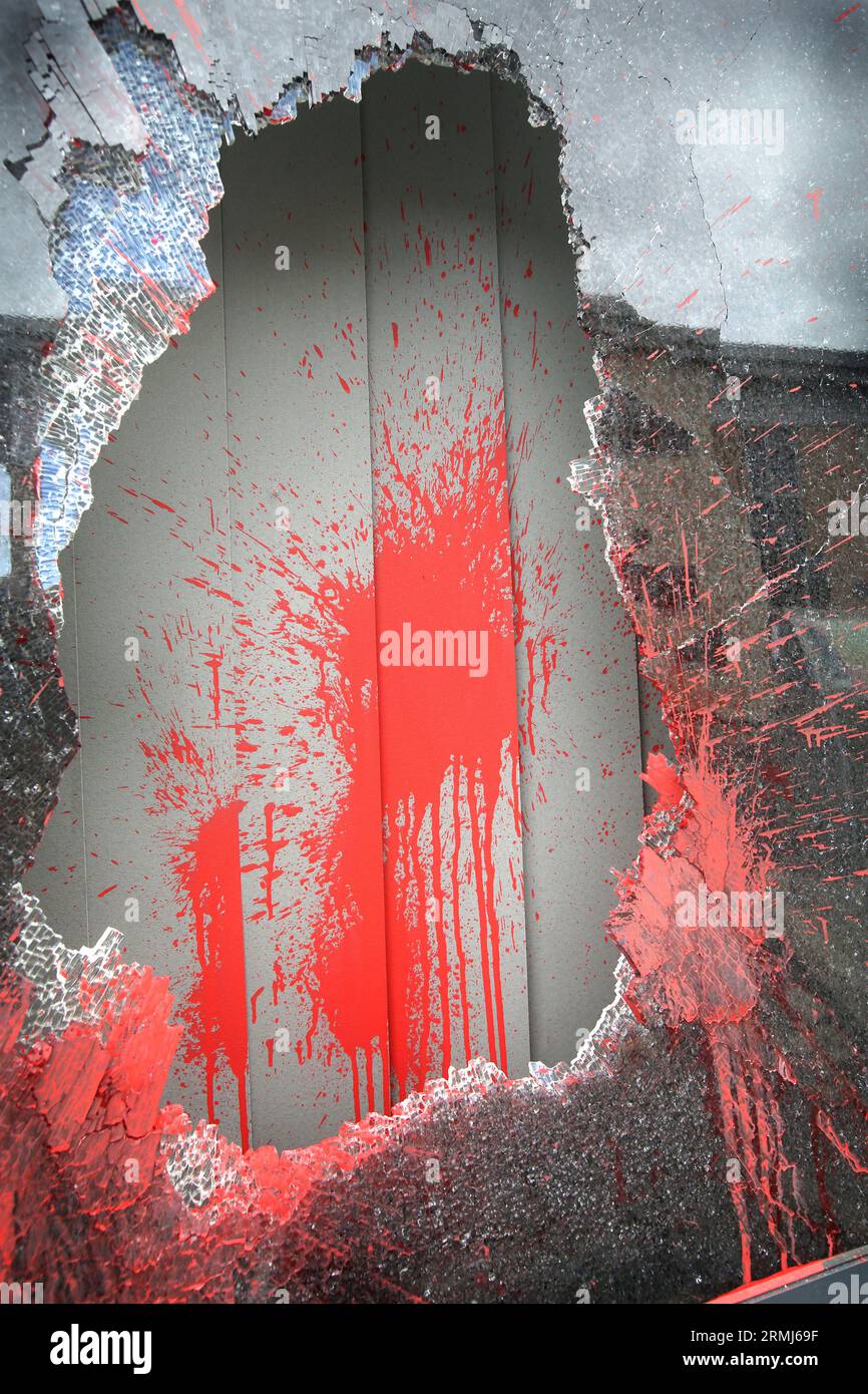 The outside of the modern building shows red paint on it's face and a ...