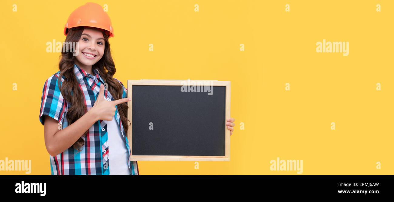 smiling teen girl laborer pointing finger on blackboard. child ...