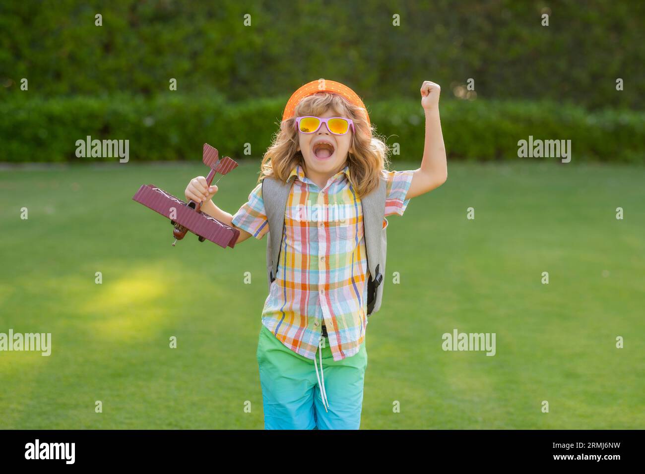 Kid playing with toy airplane and dreaming future. Happy boy pilot play ...
