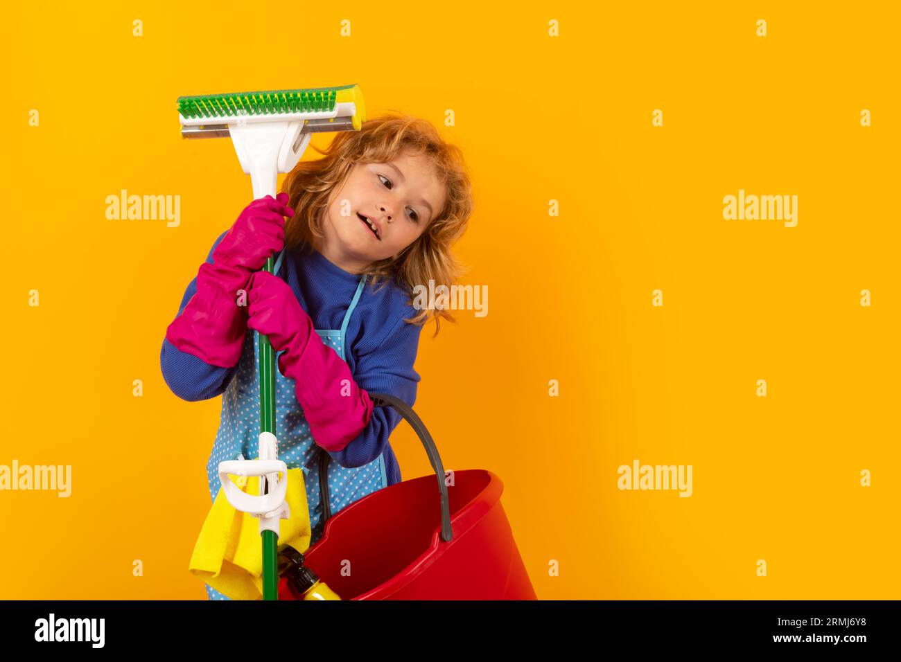 Child cleans at home concept. Kid cleaning with mop to help with ...
