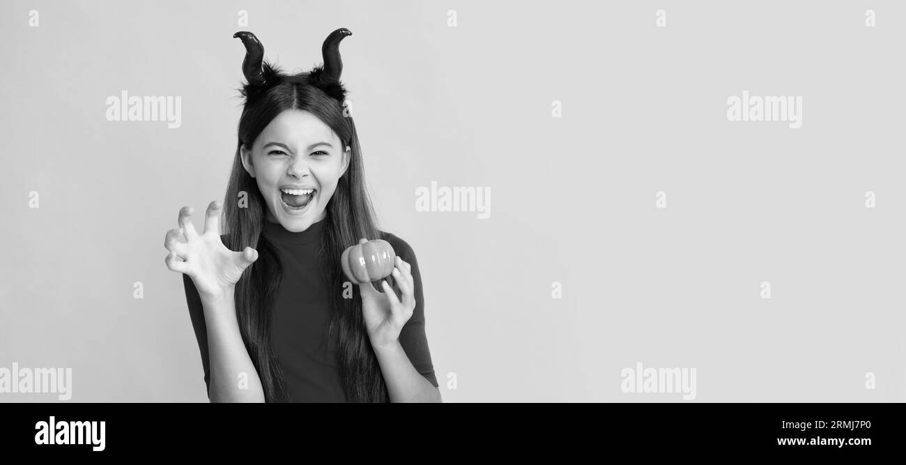 evil child in imp horns. happy halloween. devil kid with pumpkin. trick ...