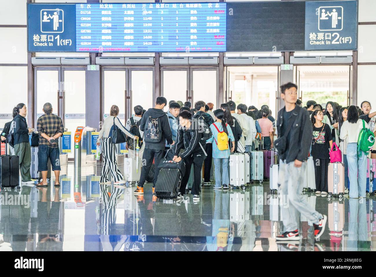 BIJIE, CHINA - AUGUST 28, 2023 - Passengers line up to check their ...