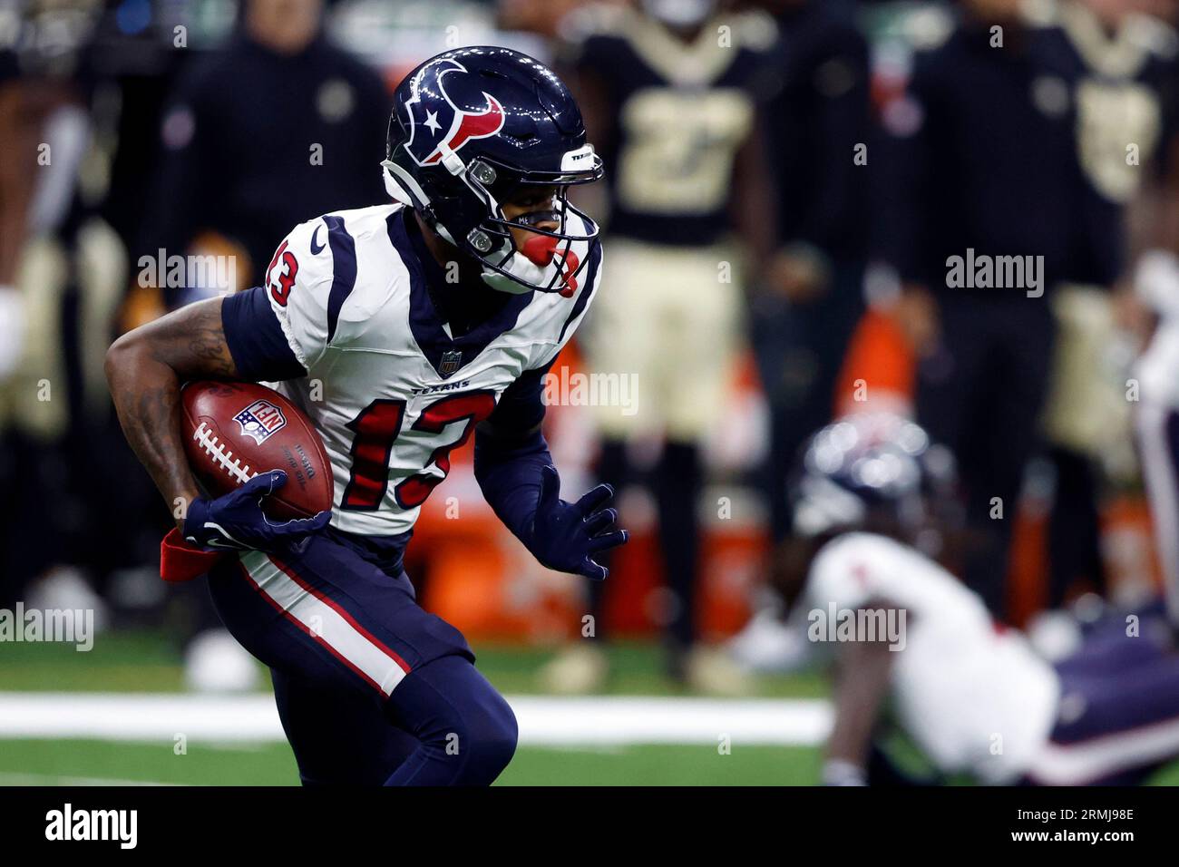 Houston Texans wide receiver Tank Dell carries the ball on a kickoff ...