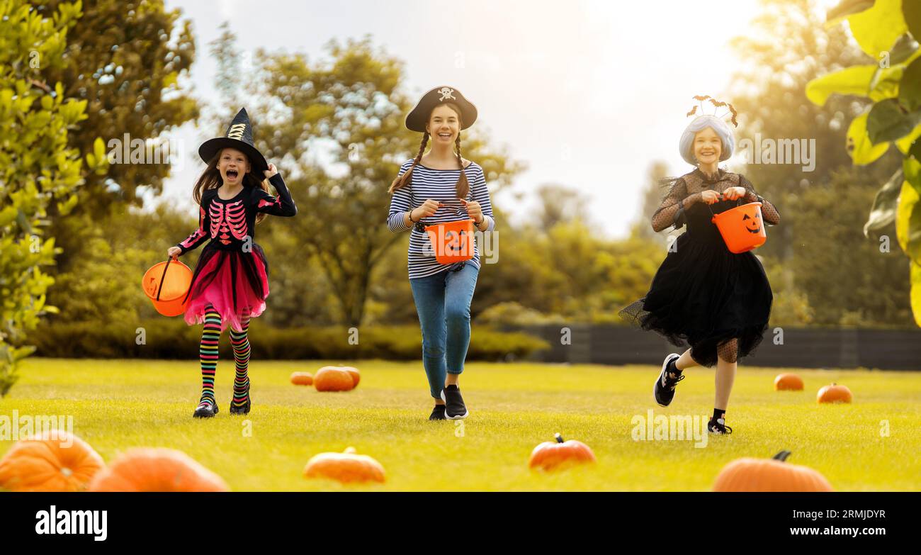 Happy kids at Halloween party. Children are wearing carnival costumes ...