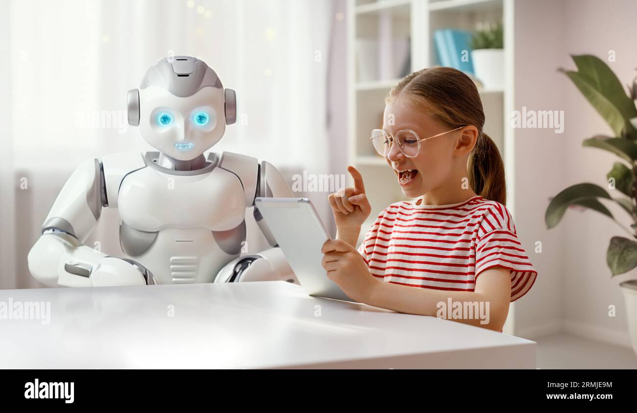 A cute girl is playing with a robot. The concept of future training ...