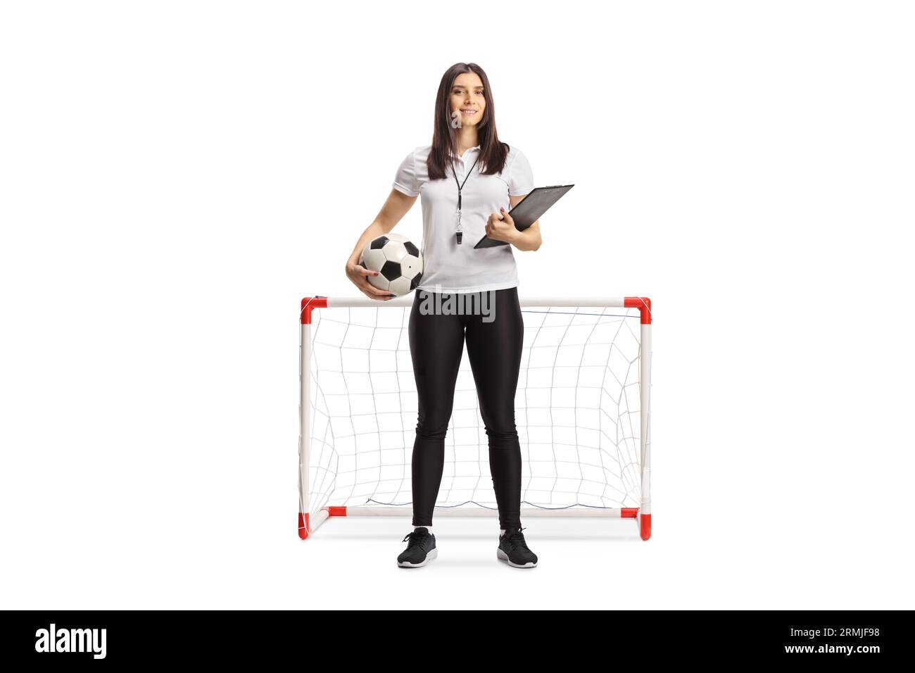 Female football coach with a whistle holding a clipboard and a ball in ...
