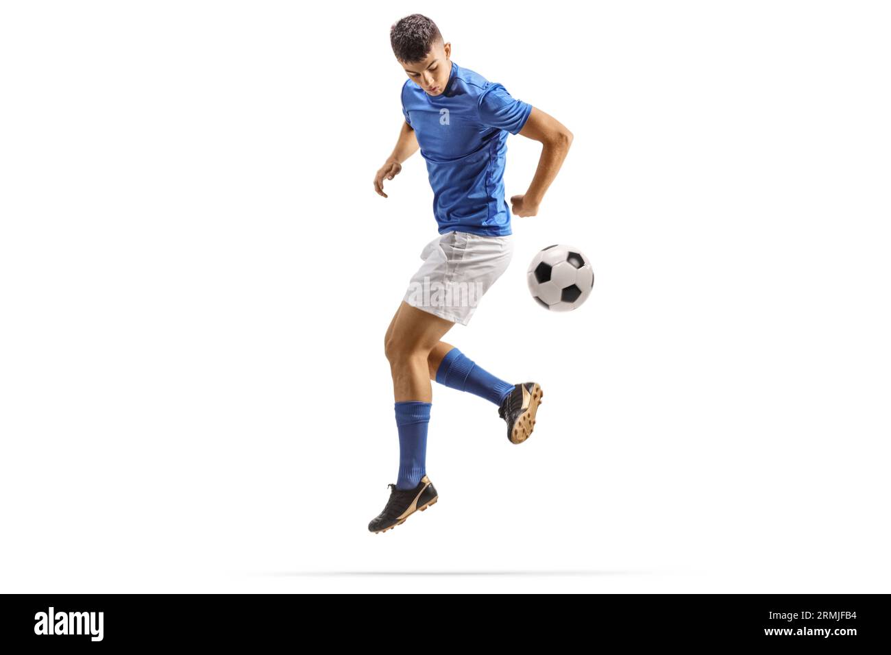 Football player kicking a ball with back heel isolated on white ...