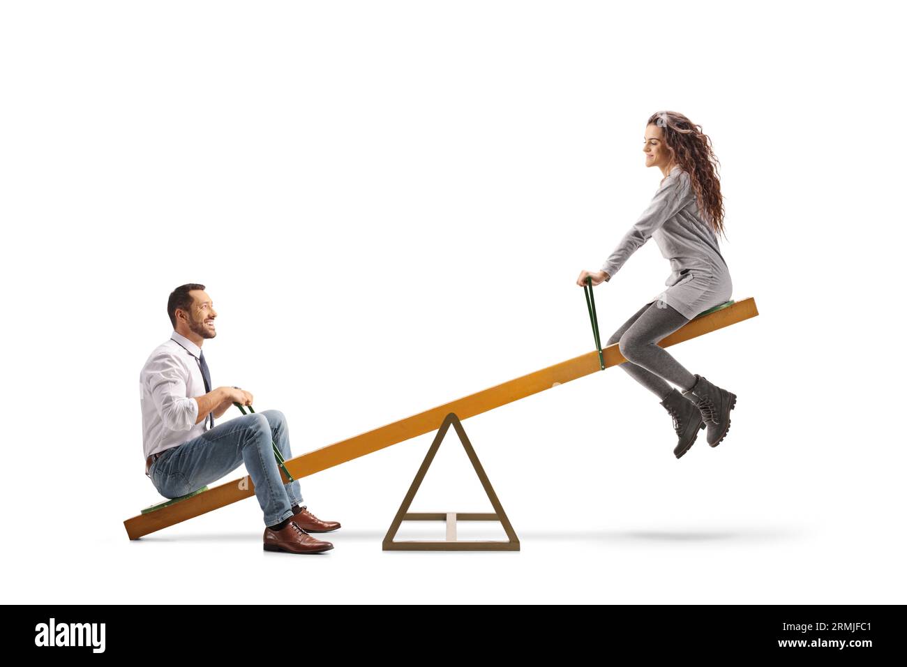 Young man and woman playing on a seesaw isolated on white background ...