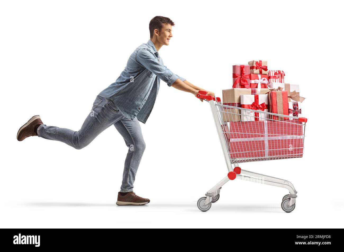 Full length profile shot of a male teenager running with presents in a ...