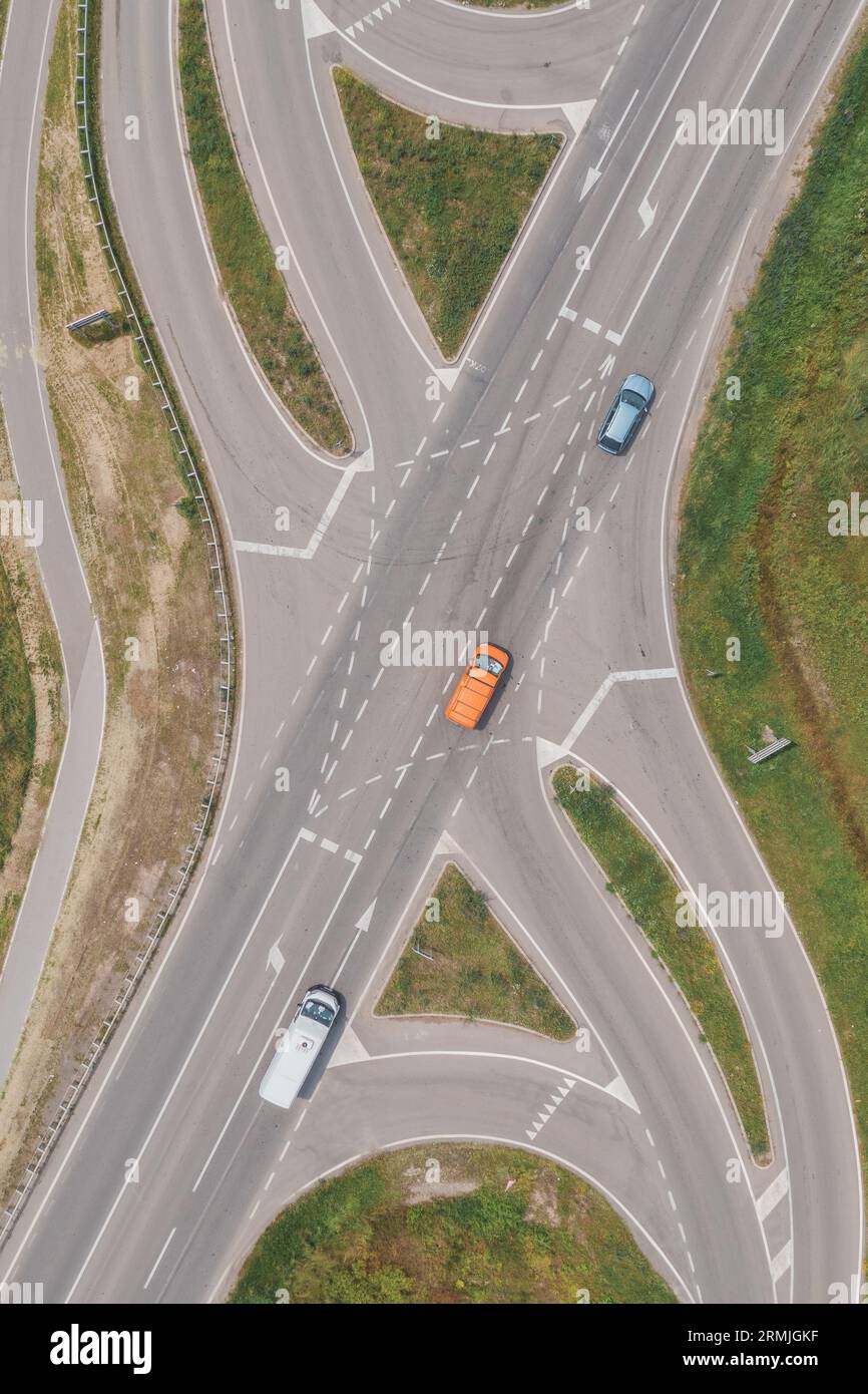Aerial view of road intersection with car, min van and small bus from ...